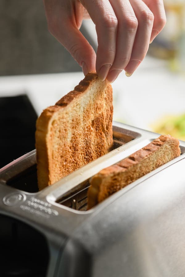 The Female Hand Pulls Out Ready Toasts Stock Image - Image of kitchen ...