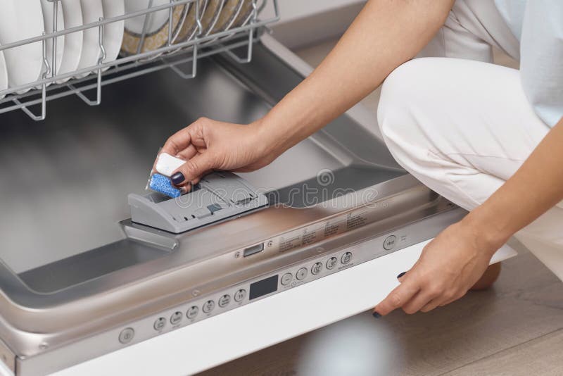 Female Hand Puts Dishwasher Tablet into Open Dishwasher Machine Stock ...