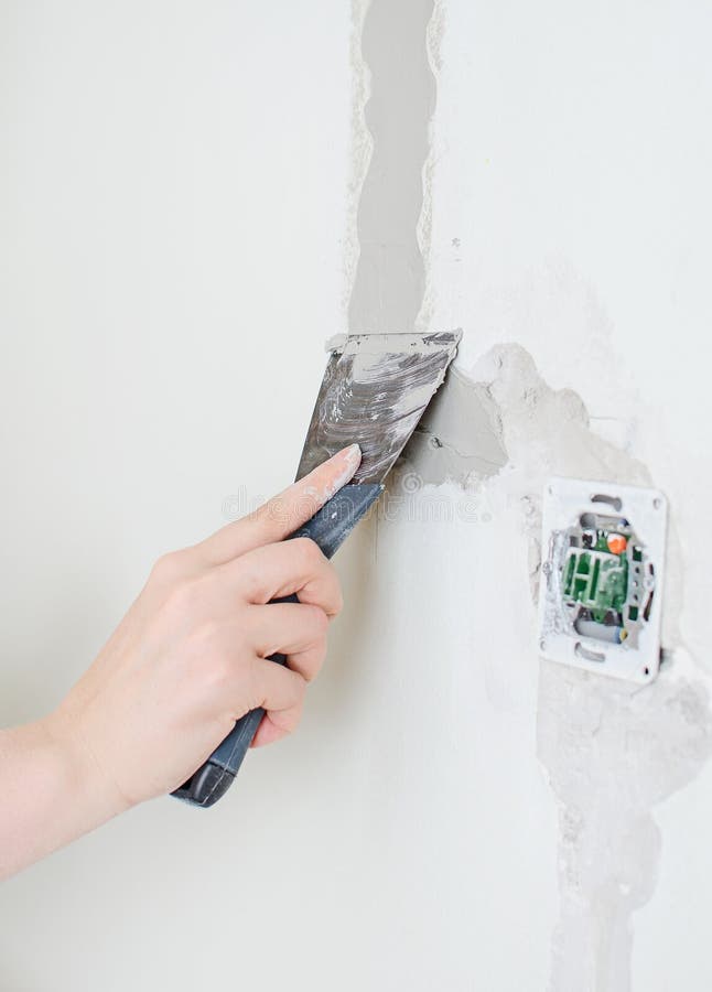 Female hand repairs wall stock image. Image of craft - 36572645