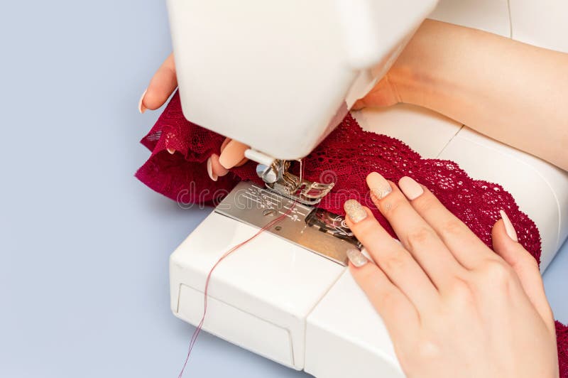 Female Hand Sewing on a Sewing Machine. Work with Lace. Close-up Stock ...