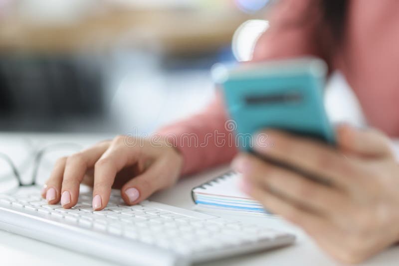 In Female Hand a Smartphone and Second Hand on Computer Keyboard Stock ...