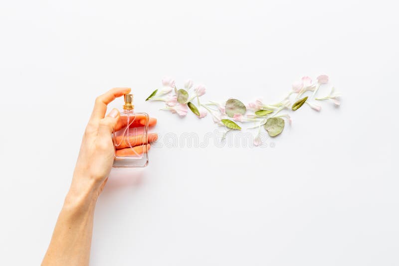 Female Hand Spray Perfume Bottle and Flow of Flowers Stock Photo ...