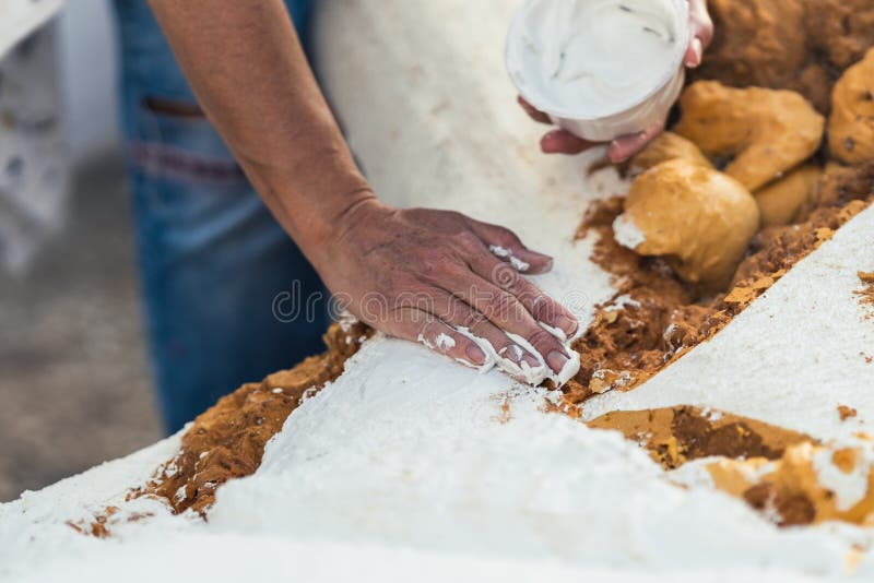 Female Hand Spreading White Paste on the Rough Surface of a Polystyrene ...