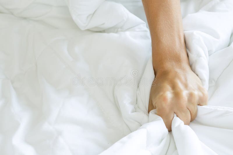 Strong Female Hand Squeezing Bed Sheet in Bedroom Stock Photo - Image ...