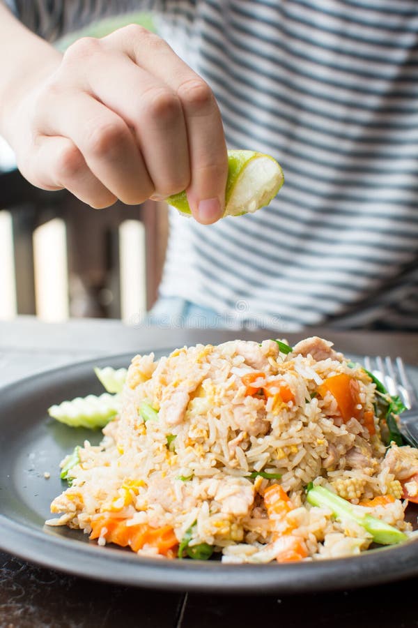 Female Hand Squeezing Lime on Fried Rice Stock Photo - Image of ...