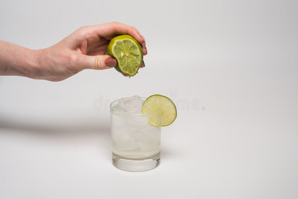 Female hand squeezing lime stock photo. Image of cocktail - 74617564
