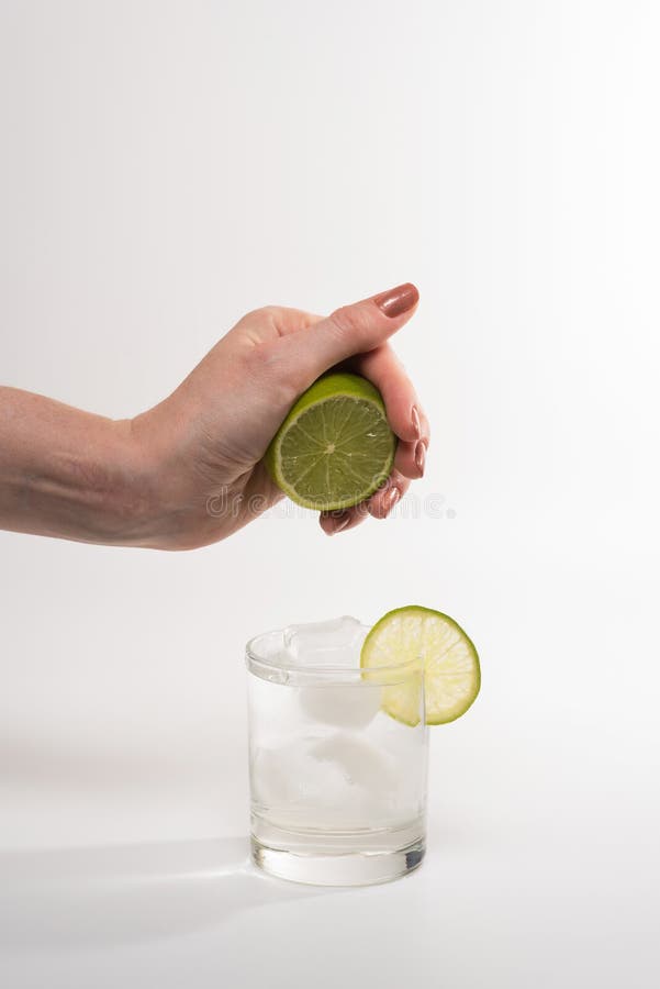 Female hand squeezing lime stock image. Image of fruit - 74617963