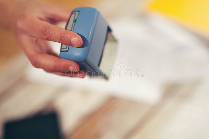 Female Hand Stamping Document Stock Photo - Image of certificate, paper ...