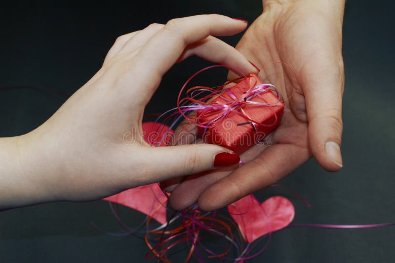 A female hand takes a gift stock image. Image of partner - 107841143