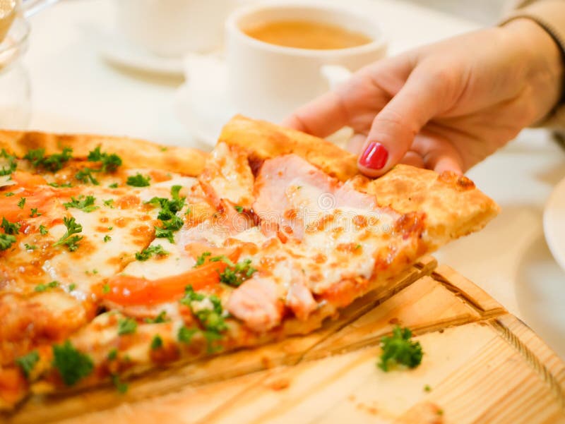 Female Hand Takes Pizza. Kind of Pizza with Bacon, Tomatoes and Herbs ...