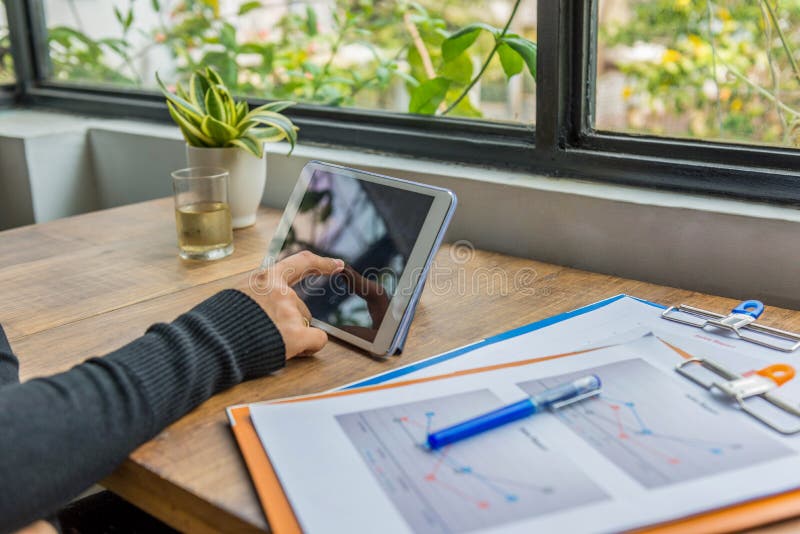 Female Hand Tapping Tablet Screen at Workplace Next To Window Stock ...