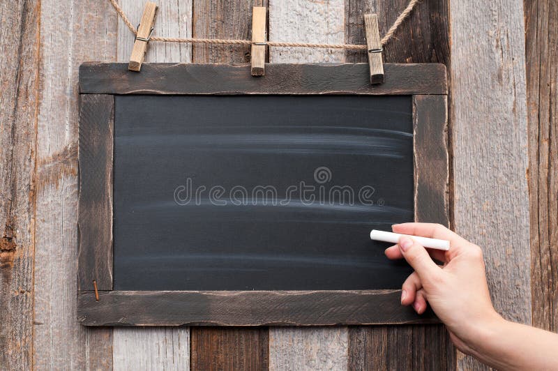 Female Hand To Draw Something on Blackboard with Chalk Stock Image ...