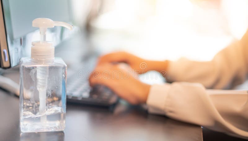 The Female Hand Typing Keyboard with the Computer Laptor and Alcohol ...
