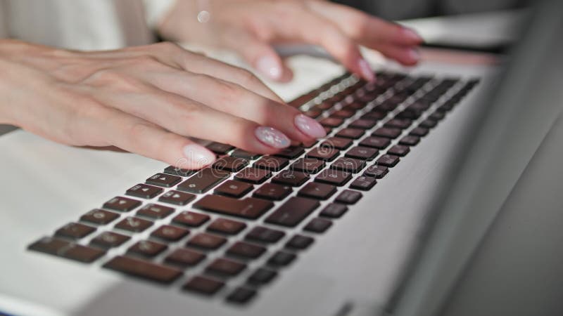 Female Hand Typing on Keyboard of a Laptop Computer Sitting at Table ...