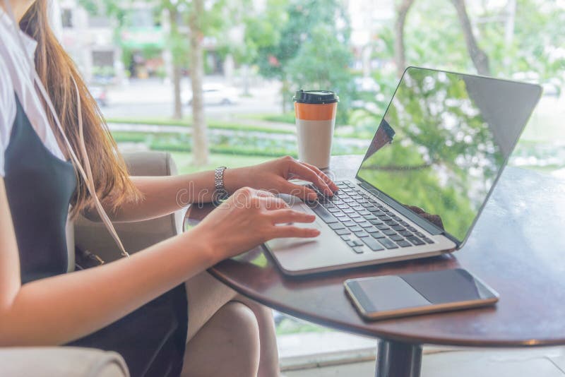 Female Hand Using Laptop with Coffee and Smart Phone beside Stock Photo ...