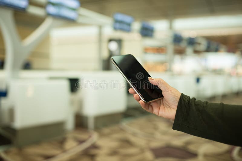 Female Hand Using Mobile Phone in Check-in Counter in Airport Terminal ...