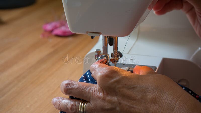 Female Hand Using Sewing Machine Stitching Fabic Stock Image - Image of ...