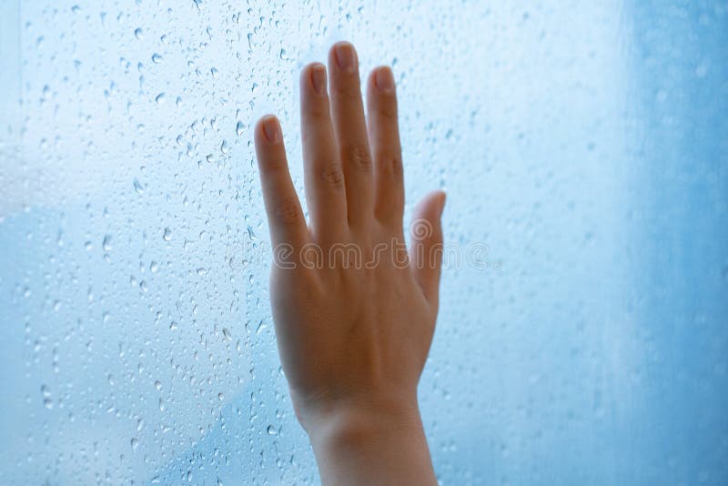 Female Hand Draws a Question Mark on a Foggy Window during the Rain. a ...
