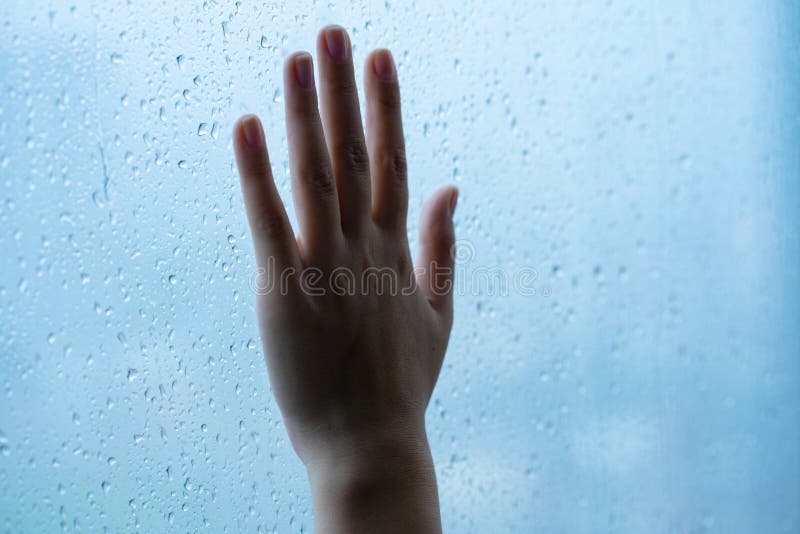 Female Hand Drawings A Heart On A Foggy Window During The Rain. Glass ...