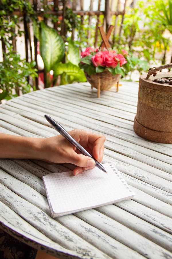 Female Hand Writing in a Notebook on Wooden Table Stock Image - Image ...