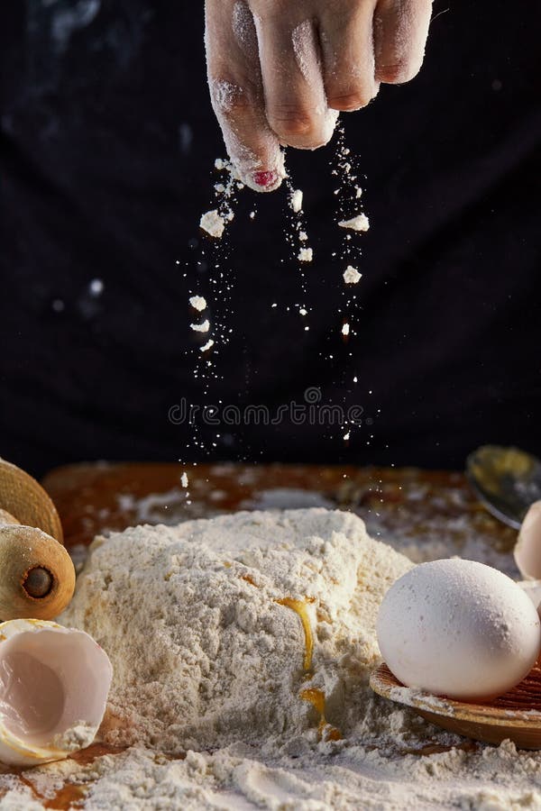 Female Hands Adding Flour To Dough, Kneading Dough for Baking. Flour in ...