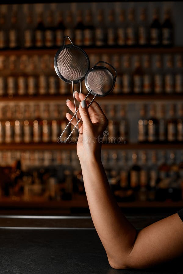 Female Hands of Bartender Holding Two Round Strainers of Different ...