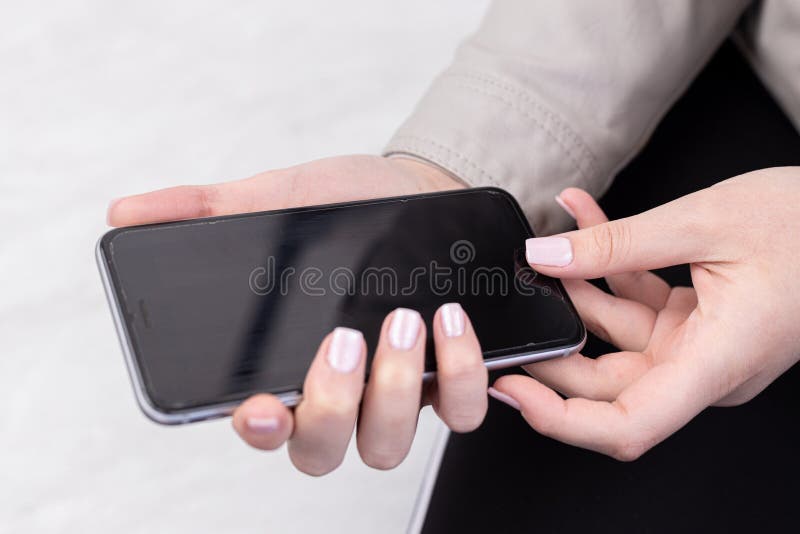 Female Hands with Beautiful Nails Holds Mobile Phone with Black Screen ...