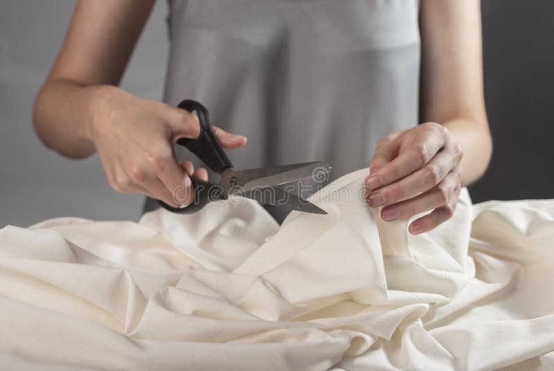 Female Hands Closeup Cutting Pastel Cloth with Sewing Scissors ...