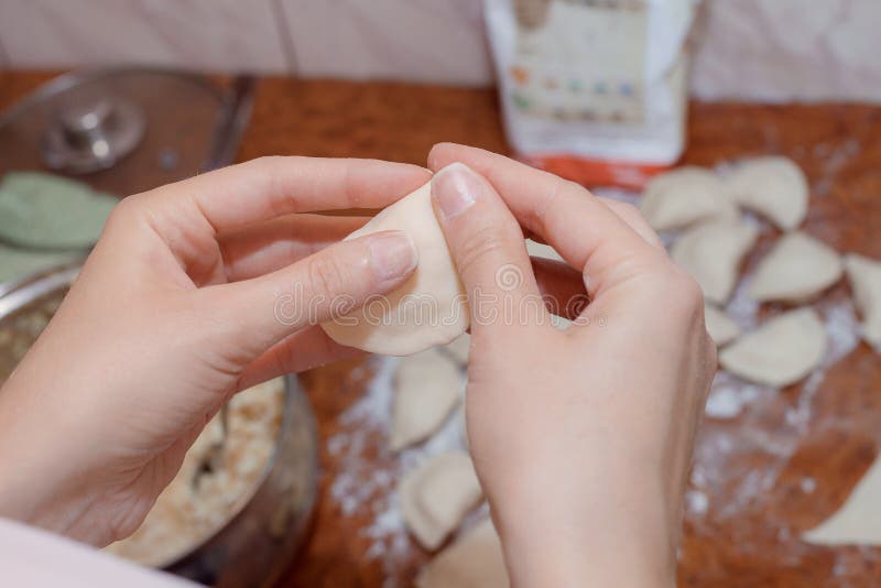 Female Hands and Cooking Dumplings. Making Dumplings. Cooking. Stock ...