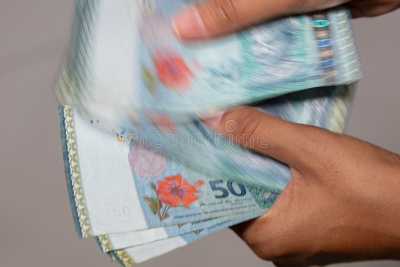Female Hands Counting Malaysian Ringgit. Human Hands Holding RM50 Stock ...
