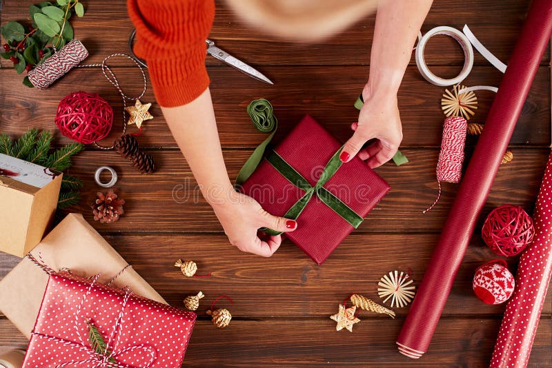 Female Hands Decorating Gift Red Boxes for Christmas Holiday. Hands ...