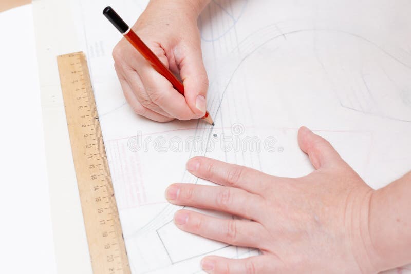 Female Hands Do the Layout of the Sewing Pattern on Paper Stock Photo ...