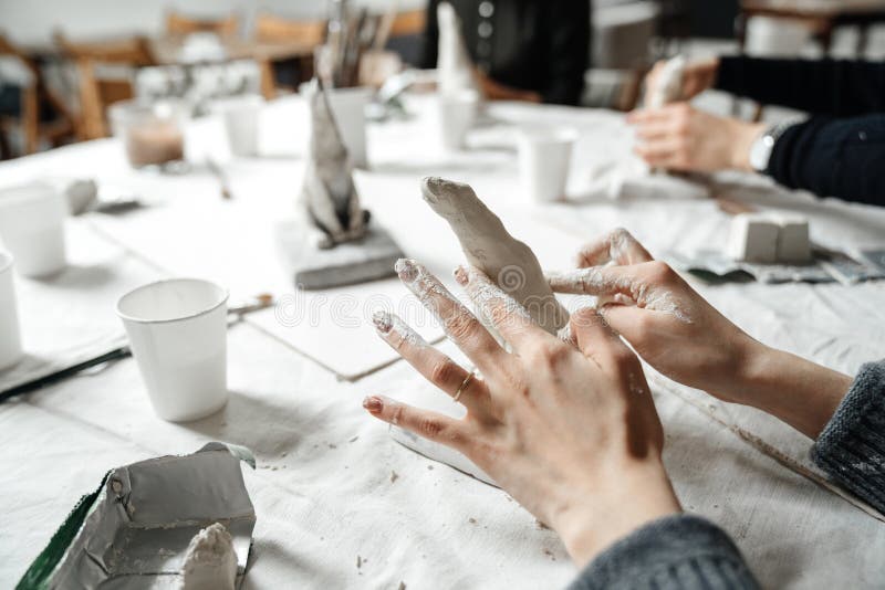 Female Hands Elegantly Shape a Small Plaster Sculpture at a Master ...