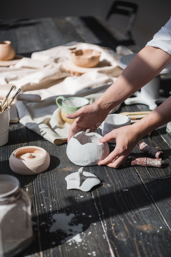 Female Hands Gently Putting the Finished Glazed Bowl on a Wooden Table ...