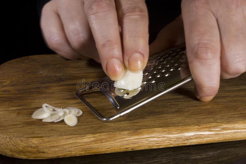 Female hands grind garlic stock photo. Image of healthy - 95176020