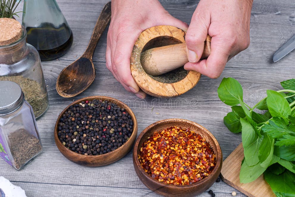 Female Hands Grind Spices in a Mortar on the Kitchen Table Stock Photo ...