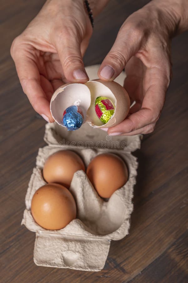 Female Hands with Half an Egg Shell, Inside Which You Can See Chocolate ...