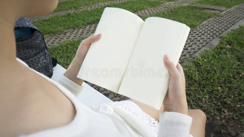 A female hands hold book stock photo. Image of human - 64340822