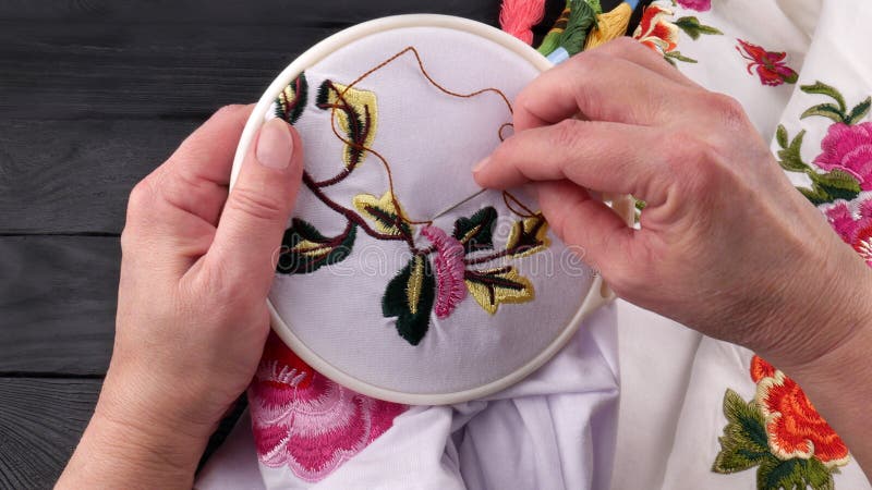 Female Hands Hold a Needle with a Thread and a Hoop in the Process of ...