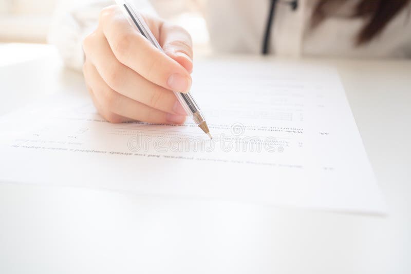 Female Hands Hold a Pen, Write on a Sheet of Paper, Fill Out a Form on ...