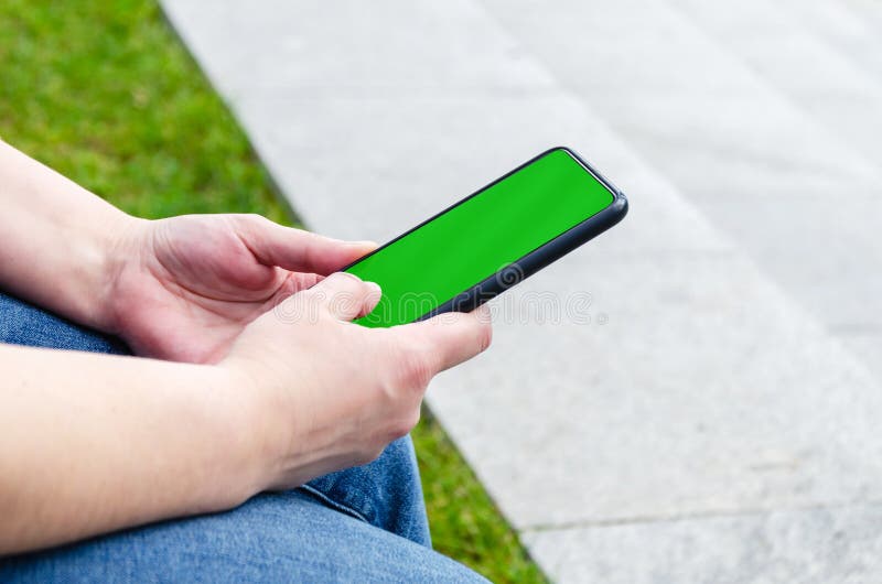 Female Hands Hold Smartphone. Green Screen, Copy Space, Chroma Key on ...