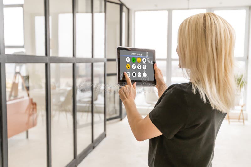 Female Hands Hold a Tablet Computer with System Clever House on a ...