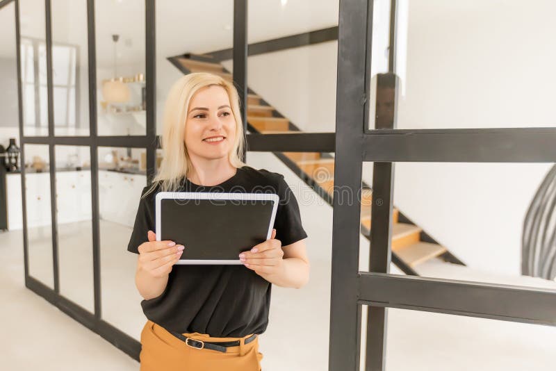 Female Hands Hold a Tablet Computer with System Clever House on a ...