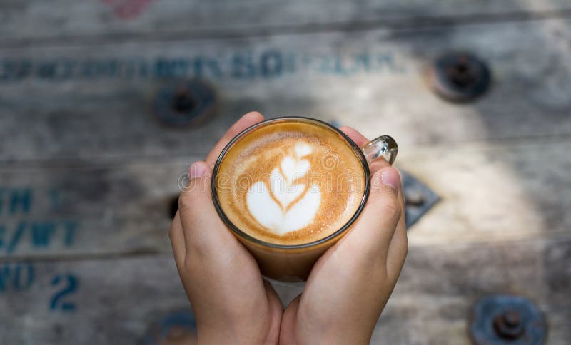 Female Hands Holding a Cup of Coffee Over Wooden Table, Top View Stock ...