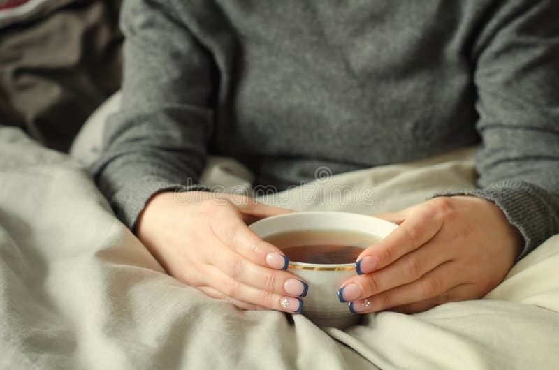 Female Hands Holding a Cup of Hot Tea on Warm Blanket. Stock Photo ...