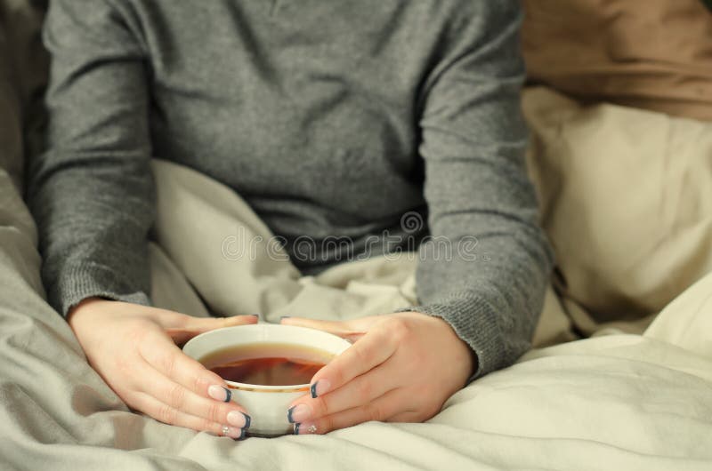 Female Hands Holding a Cup of Hot Tea on Warm Blanket. Stock Photo ...