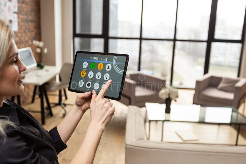 Holding Digital Tablet in Cozy Living Room with Fireplace on Background ...