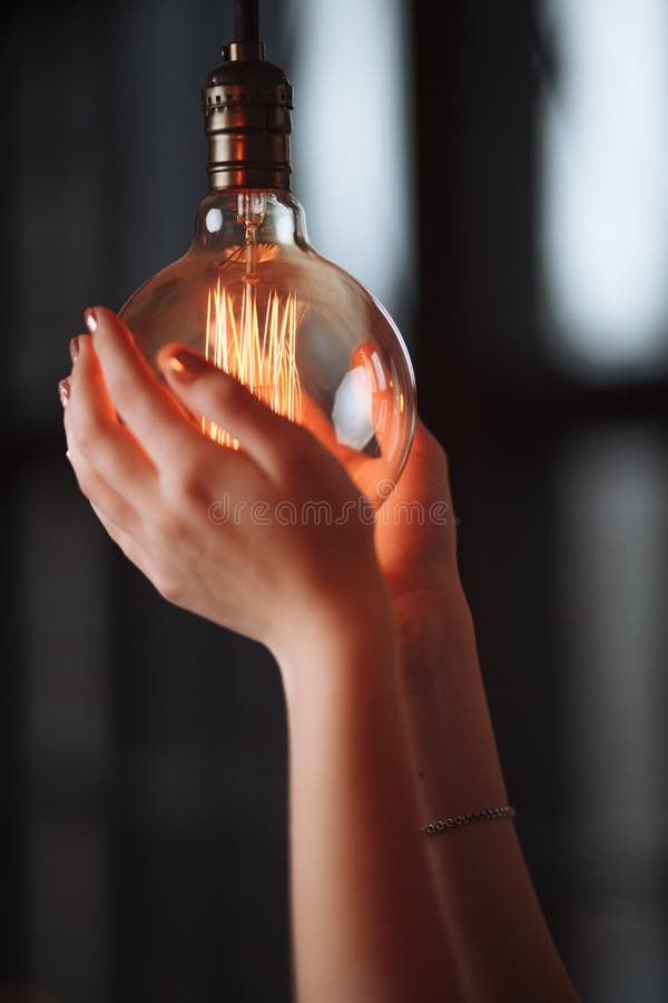 Female Hands Holding a Large Incandescent Lamp in the Studio Stock ...