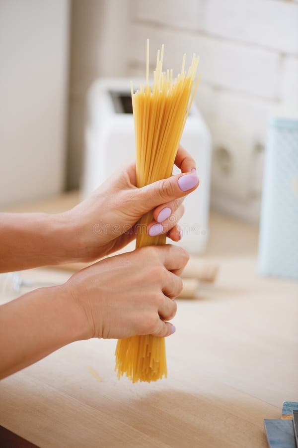 Female Hands Holding Spaghetti in the Kitchen. Stock Image - Image of ...