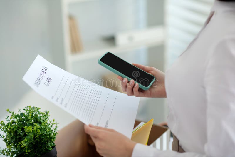 Female Hands Holding Unemployment Claim and Mobile Stock Image - Image ...